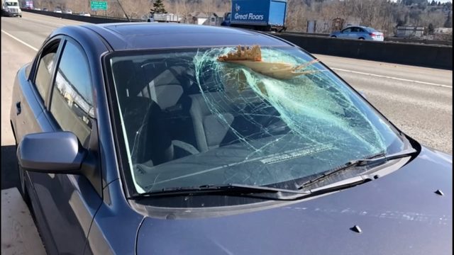 Driver narrowly escapes injury as large board crashes through ...